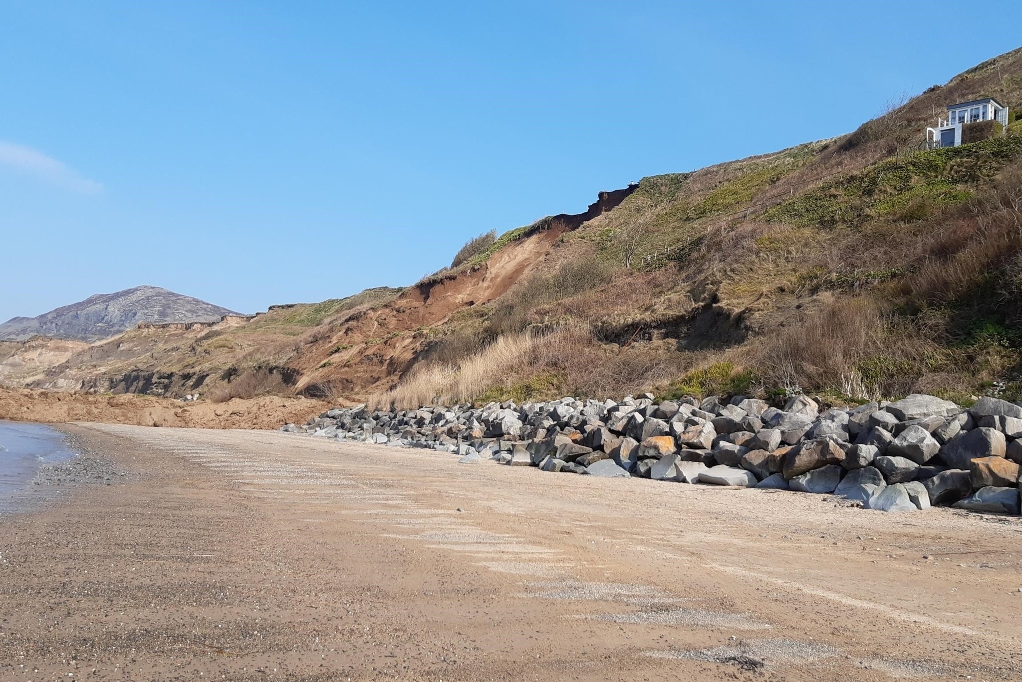 Large landslide sees clifftop gardens tumble down to Welsh beach ...