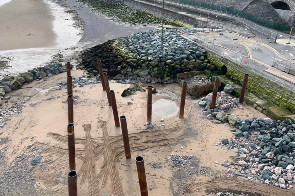Historic north Wales sea wall strengthened by sheet piling works ...