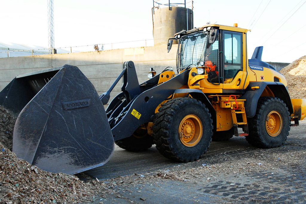 Loading shovel shifts wood piles | MRW