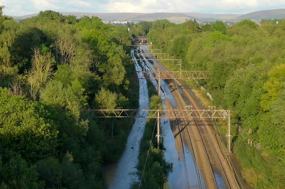 Network Rail forced to close line in Manchester after burst water main ...