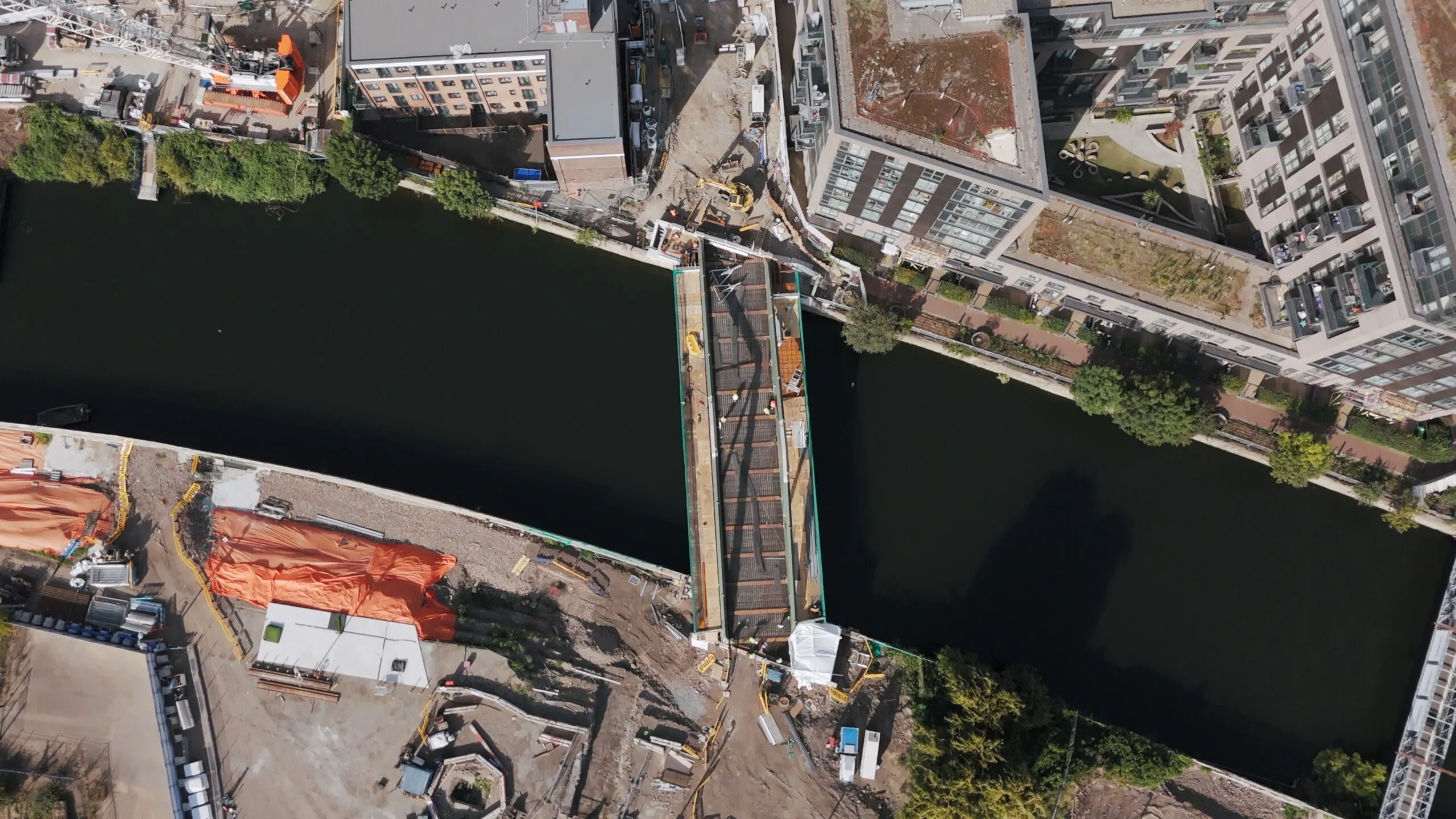 Watch a 320t footbridge sail down an East London waterway for ...