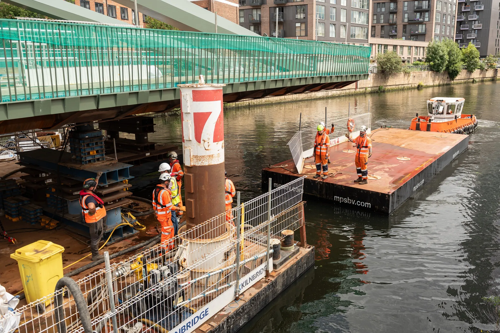 Watch a 320t footbridge sail down an East London waterway for ...